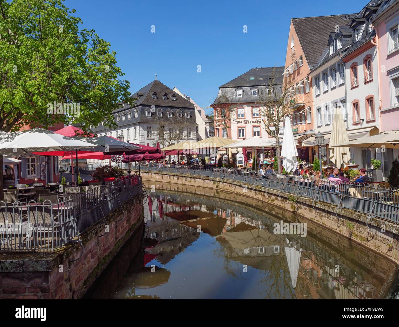 Canal scene with busy streets, restaurants, colourful buildings and ...