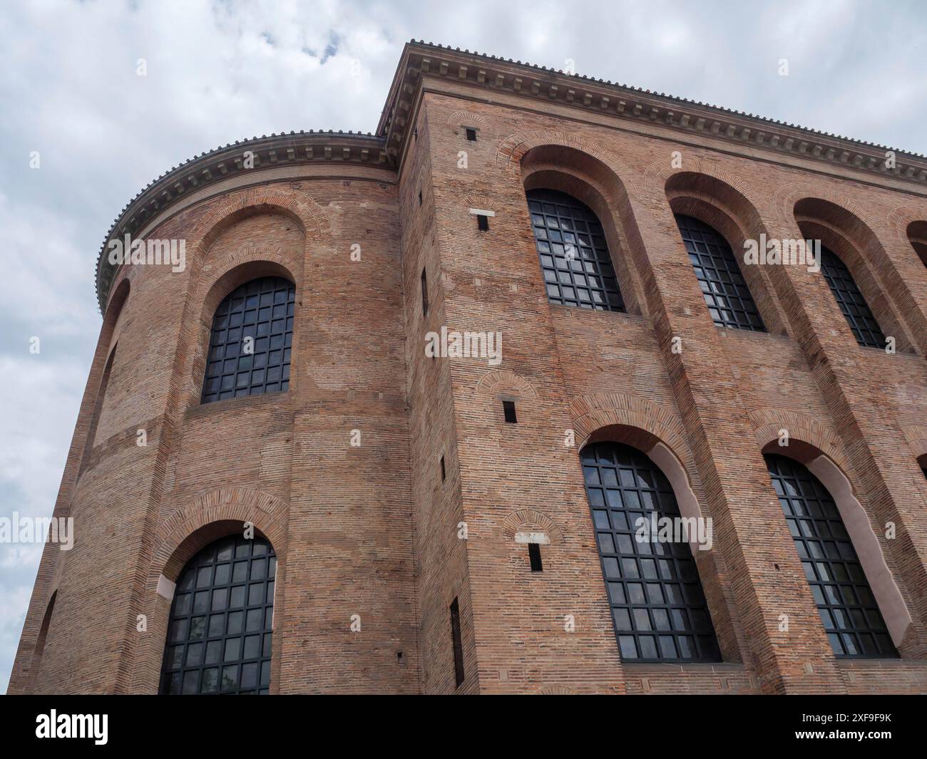 Side view of a Romanesque building with high window arches and massive ...