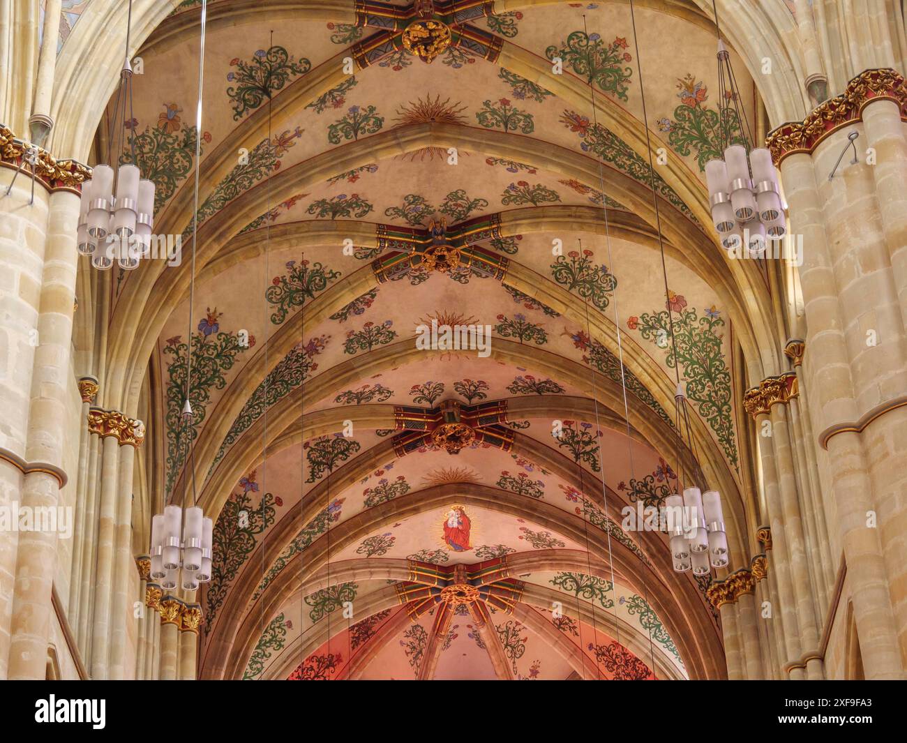 The interior of a church with ornate frescoes on the vaulted ceiling ...