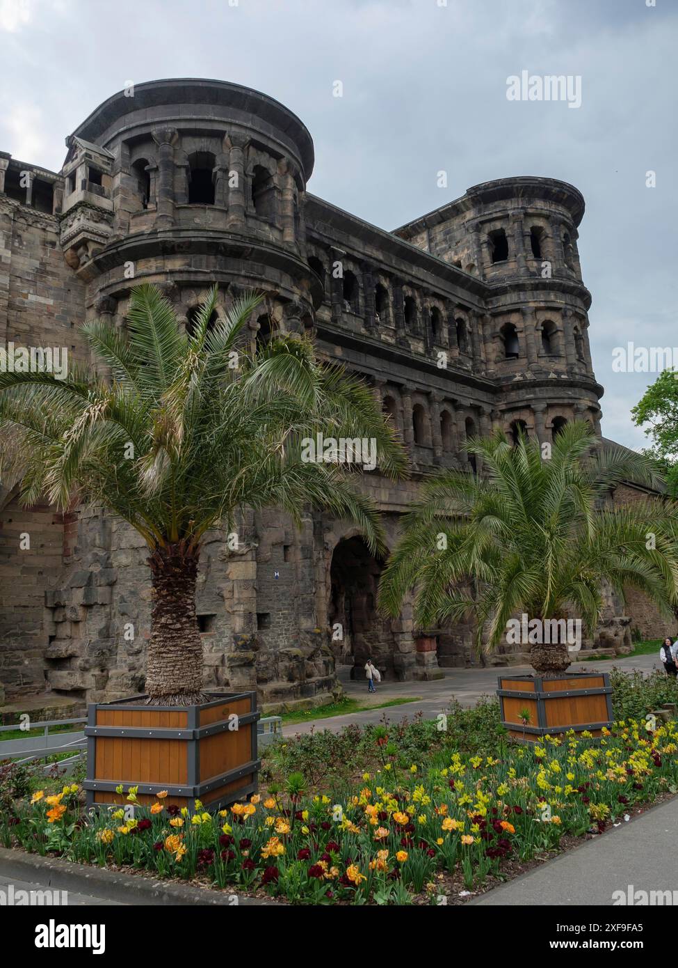 The impressive ancient Roman Tor tor Porta Nigra with palm trees in ...