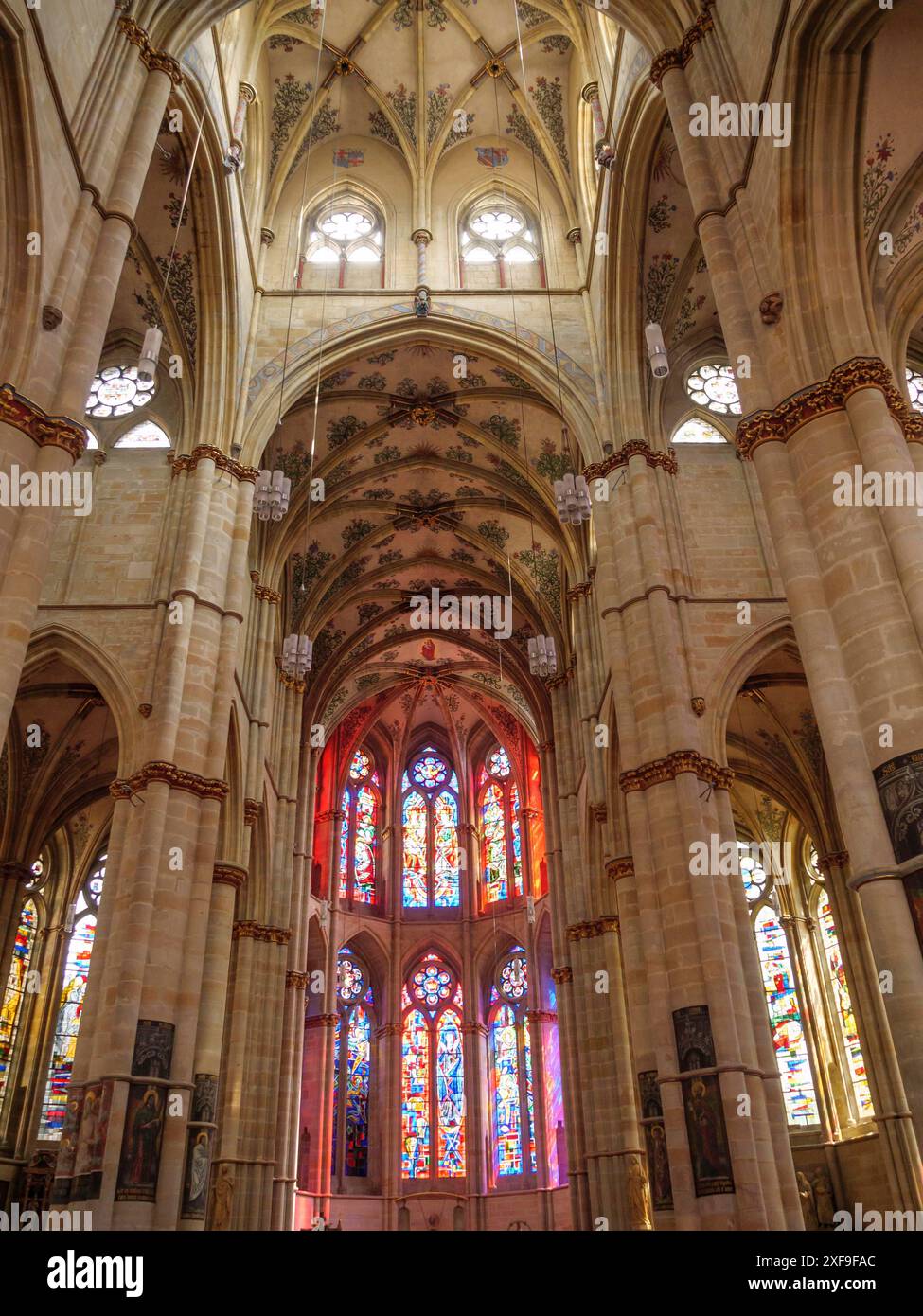 The impressive interior of a Gothic church with colourfully glazed ...