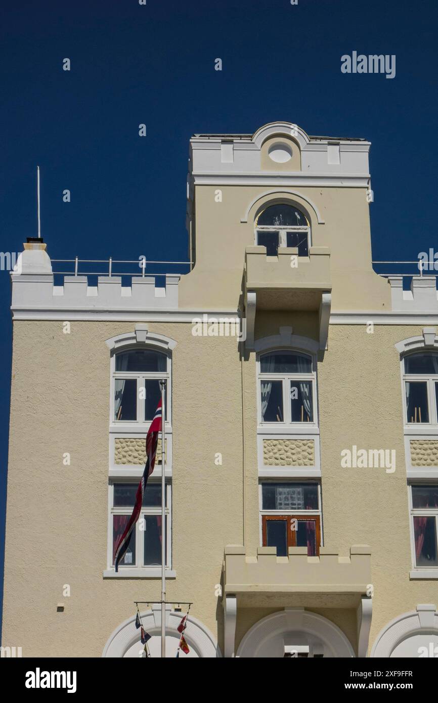 Historic building with yellow facade and windows under a blue sky ...