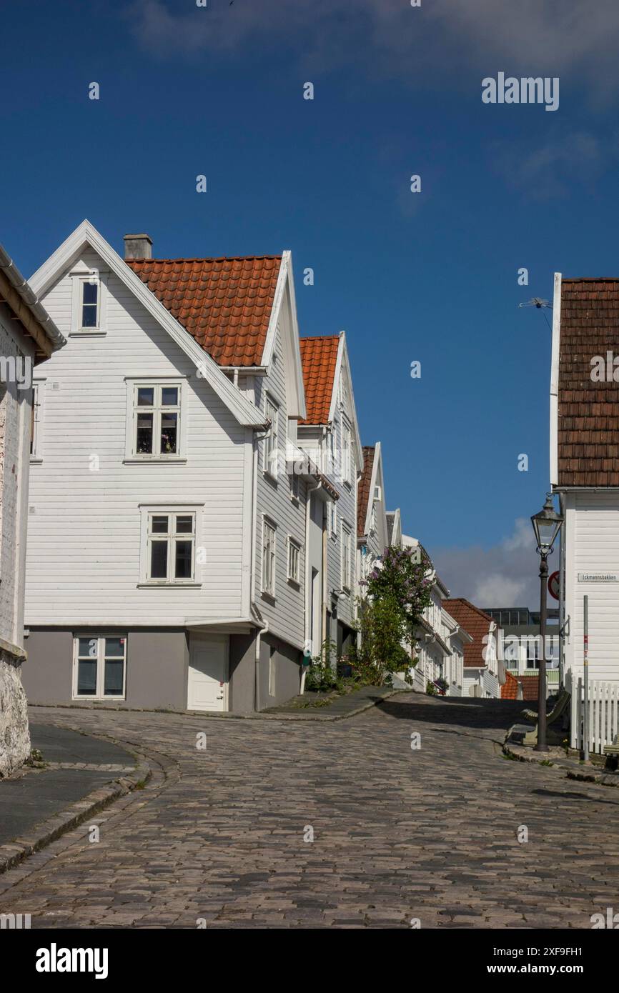 Stone road lined with white houses under a clear blue sky, stavanger ...