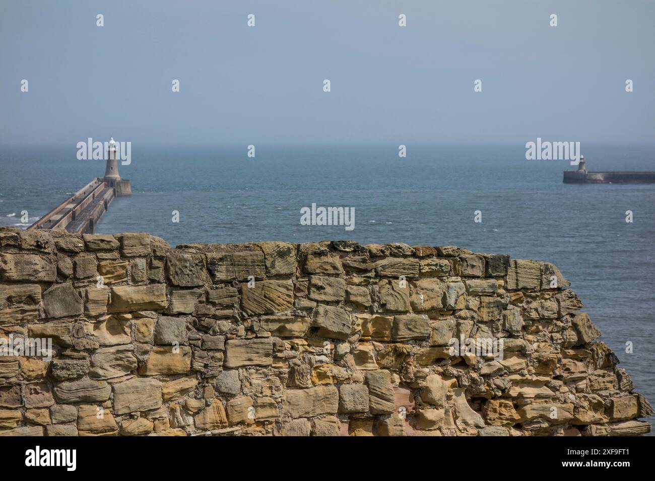 Two lighthouses and a stone wall with sweeping views of the sea ...