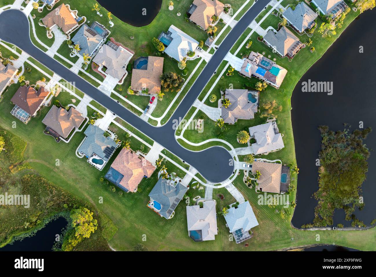 Upscale suburban homes with large backyards and green grassy lawns ...