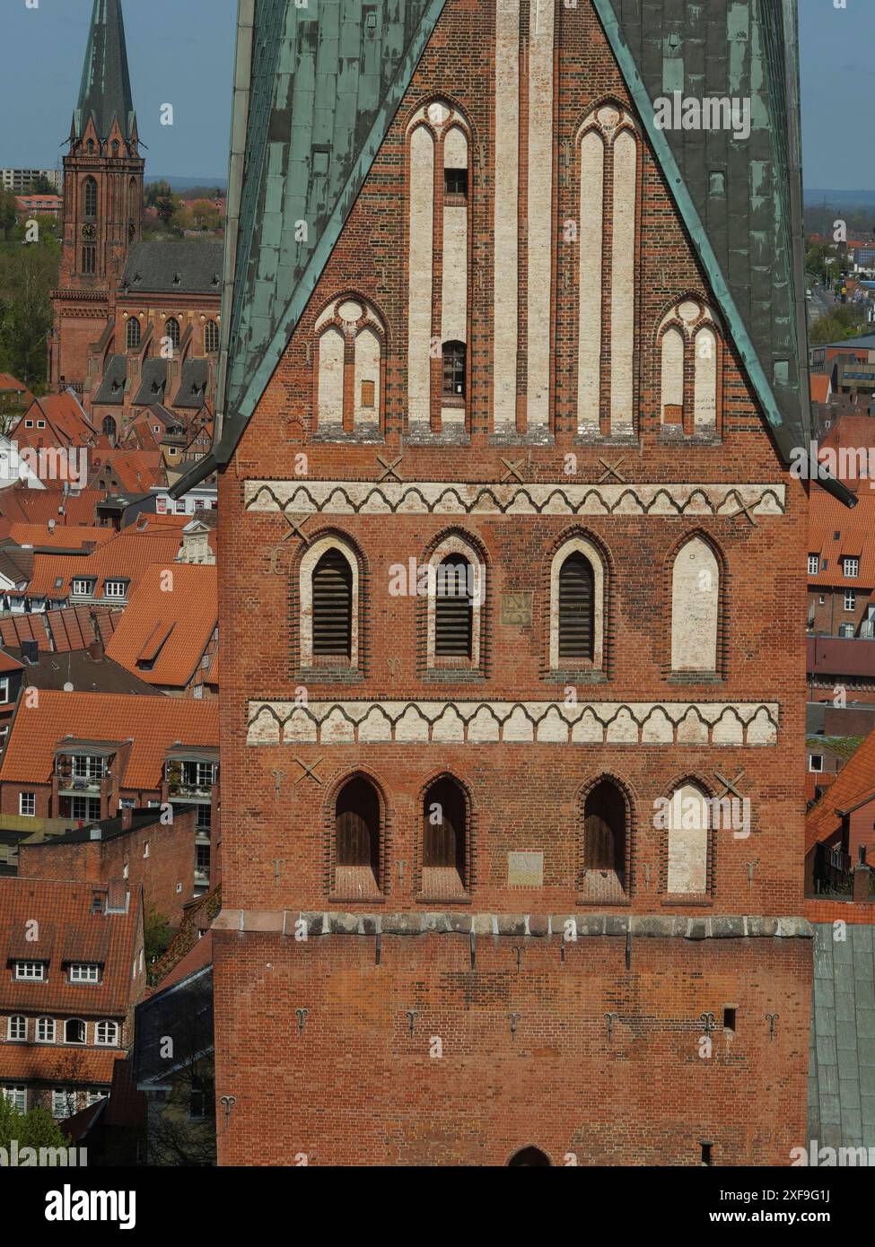 Large church tower with brick wall towers over the cityscape with red ...