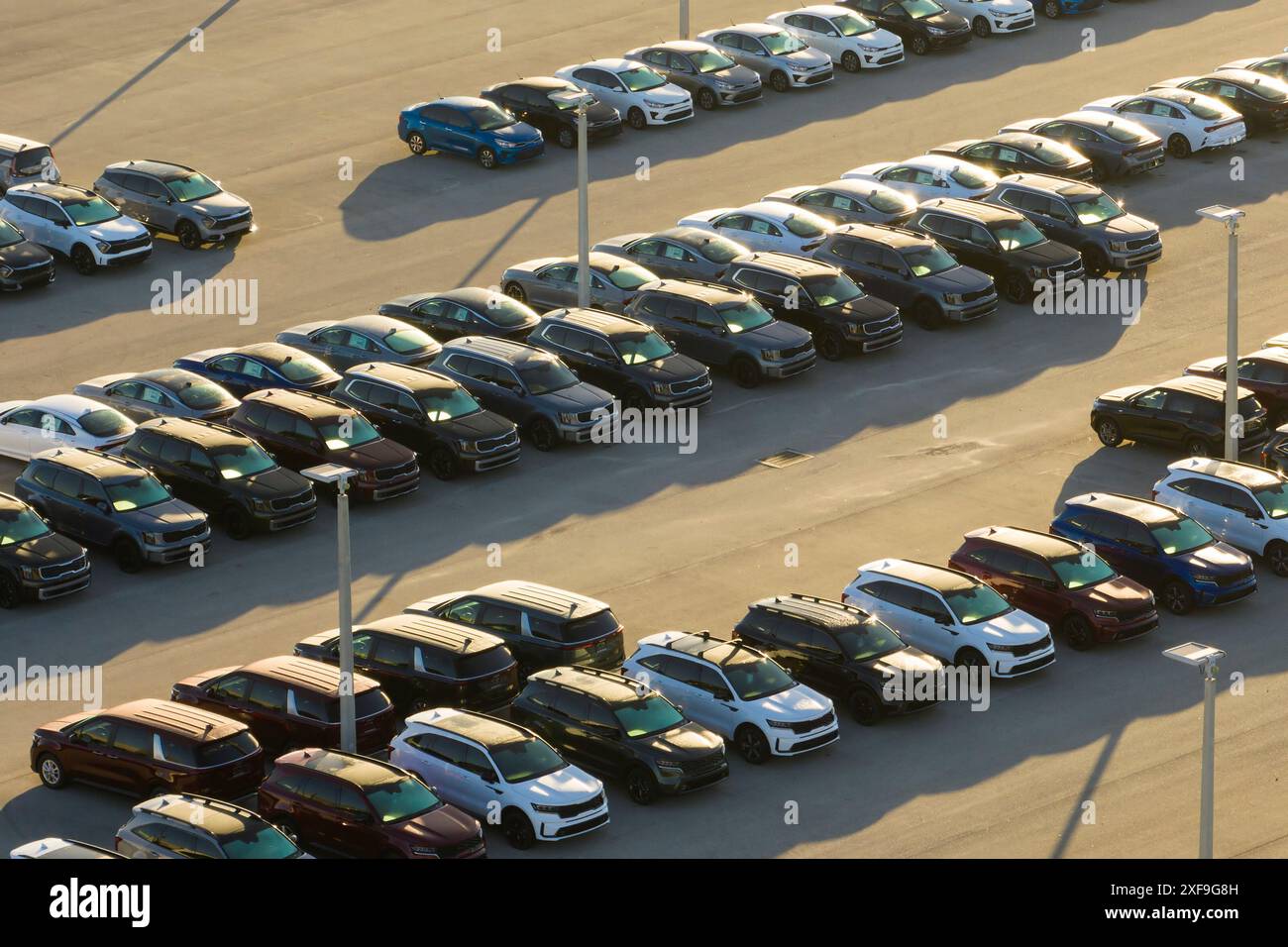 View from above of dealers outdoor parking lot with many brand new cars ...