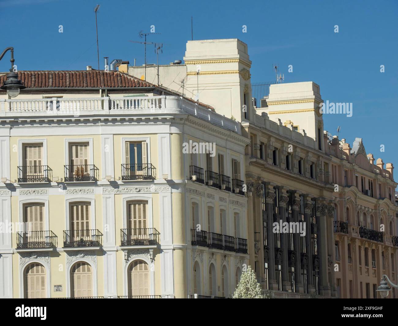 Facade of a historic building, white and beige colours, with balconies ...