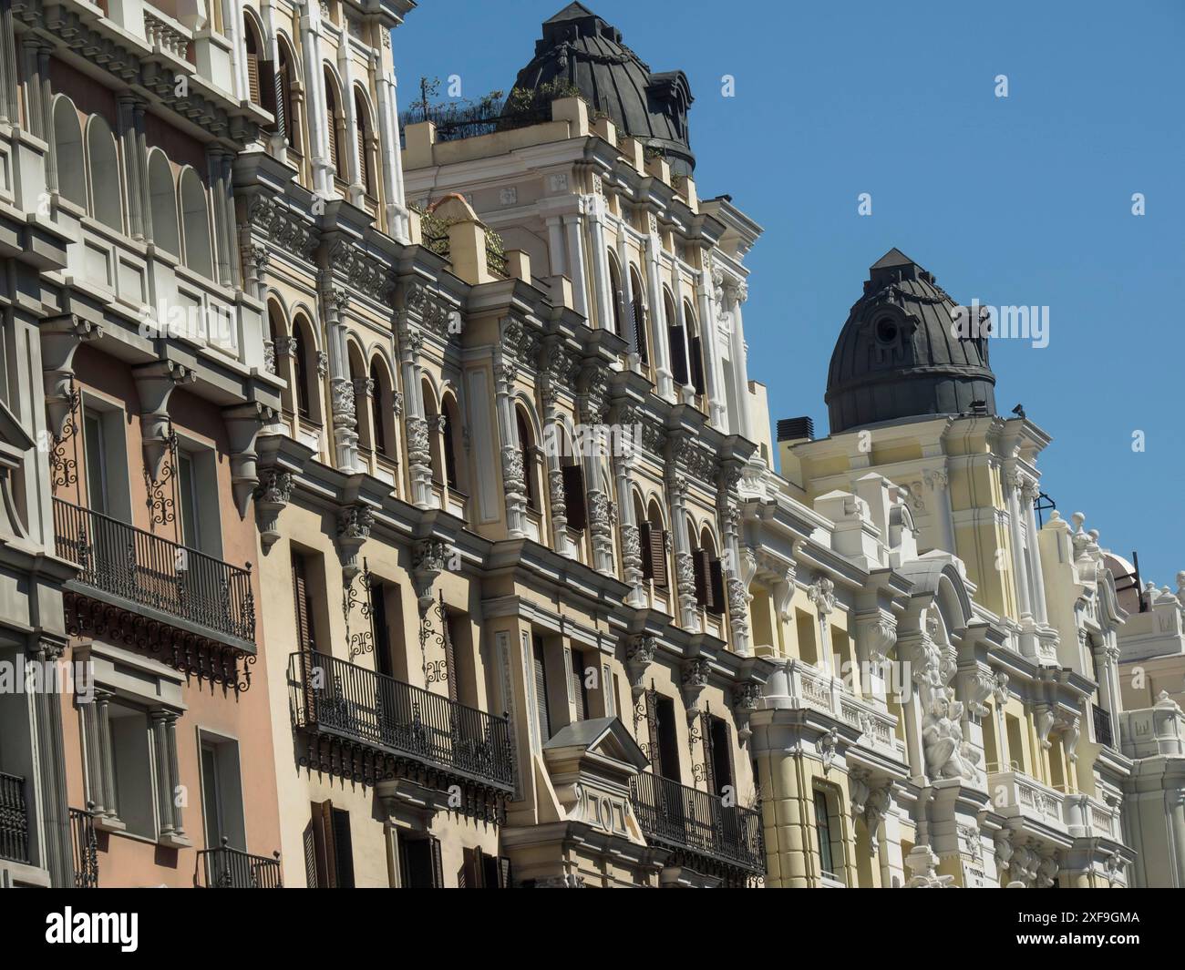 Decorated facades of historic buildings under a clear sky, madrid ...