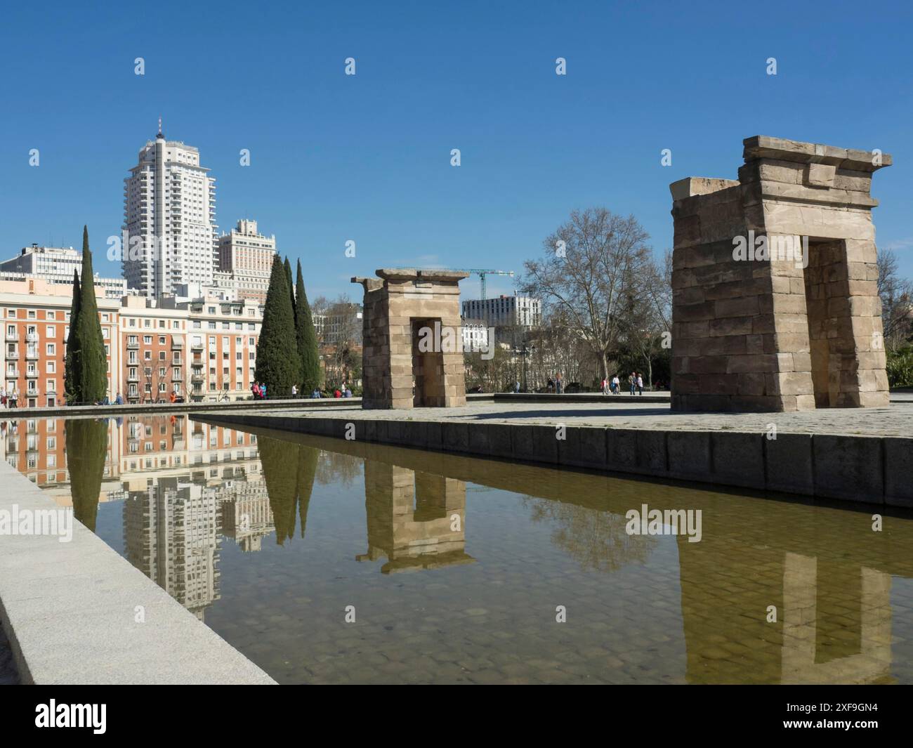 Reflection of ancient temple structures in a water basin, surrounded by ...