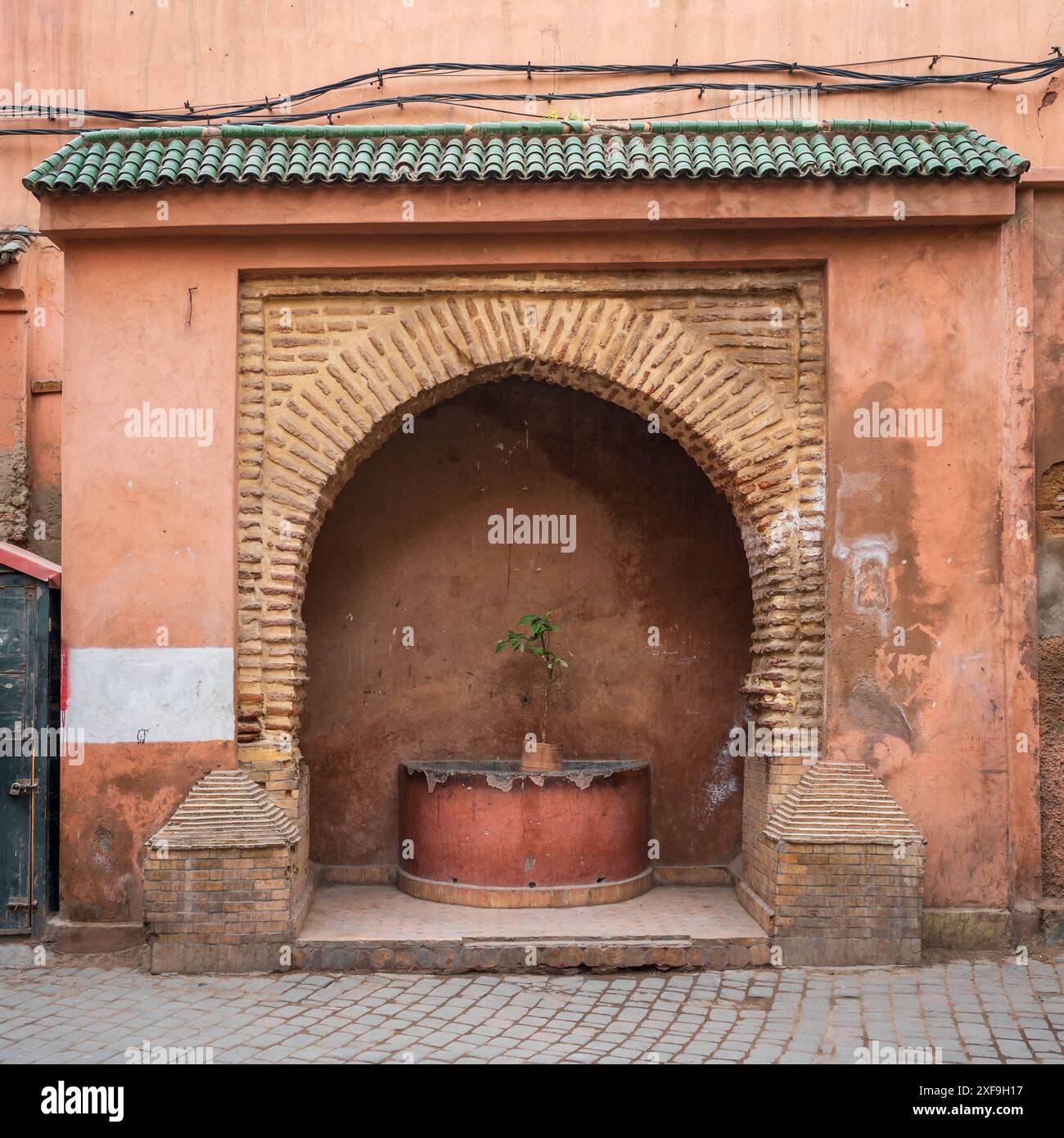Morrocan wall fountain, disused, in the Medina of Marrakesh, with a ...