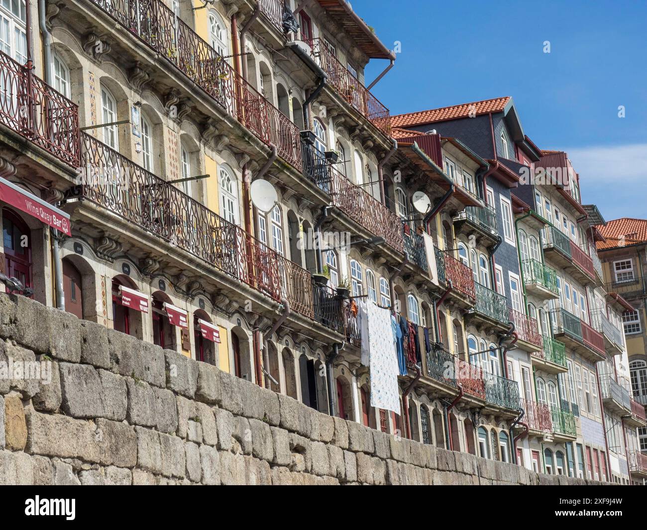 Multi-storey, colourful house facades with ornate balconies along an ...