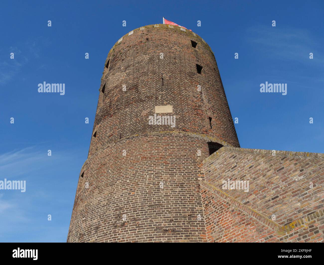 Old medieval brick tower under a clear blue sky, rees, lower rhine ...
