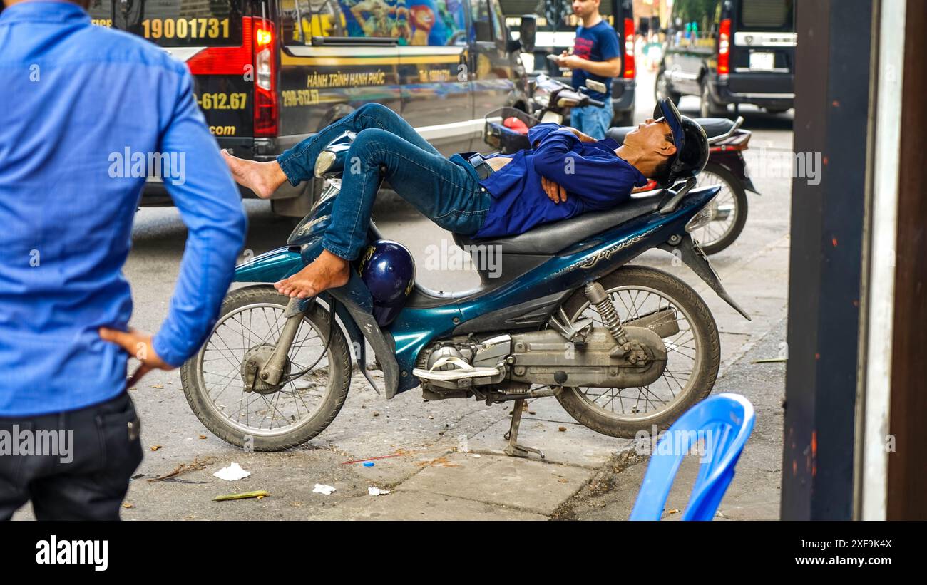 Vietnam Hanoi street scene sleeping motorbike Stock Photo - Alamy