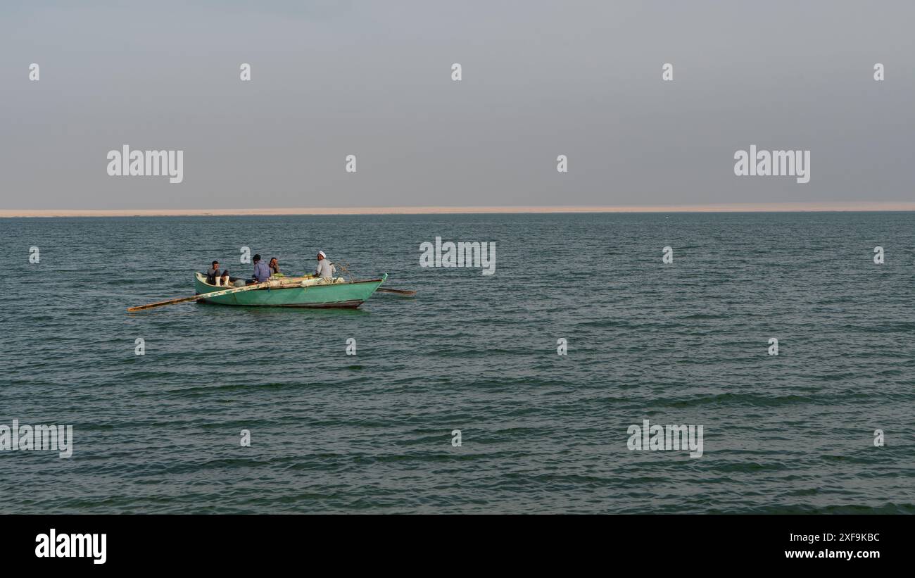 People in a boat in the Magic Lake in Wadi El Rayan in Fayoum, Egypt ...