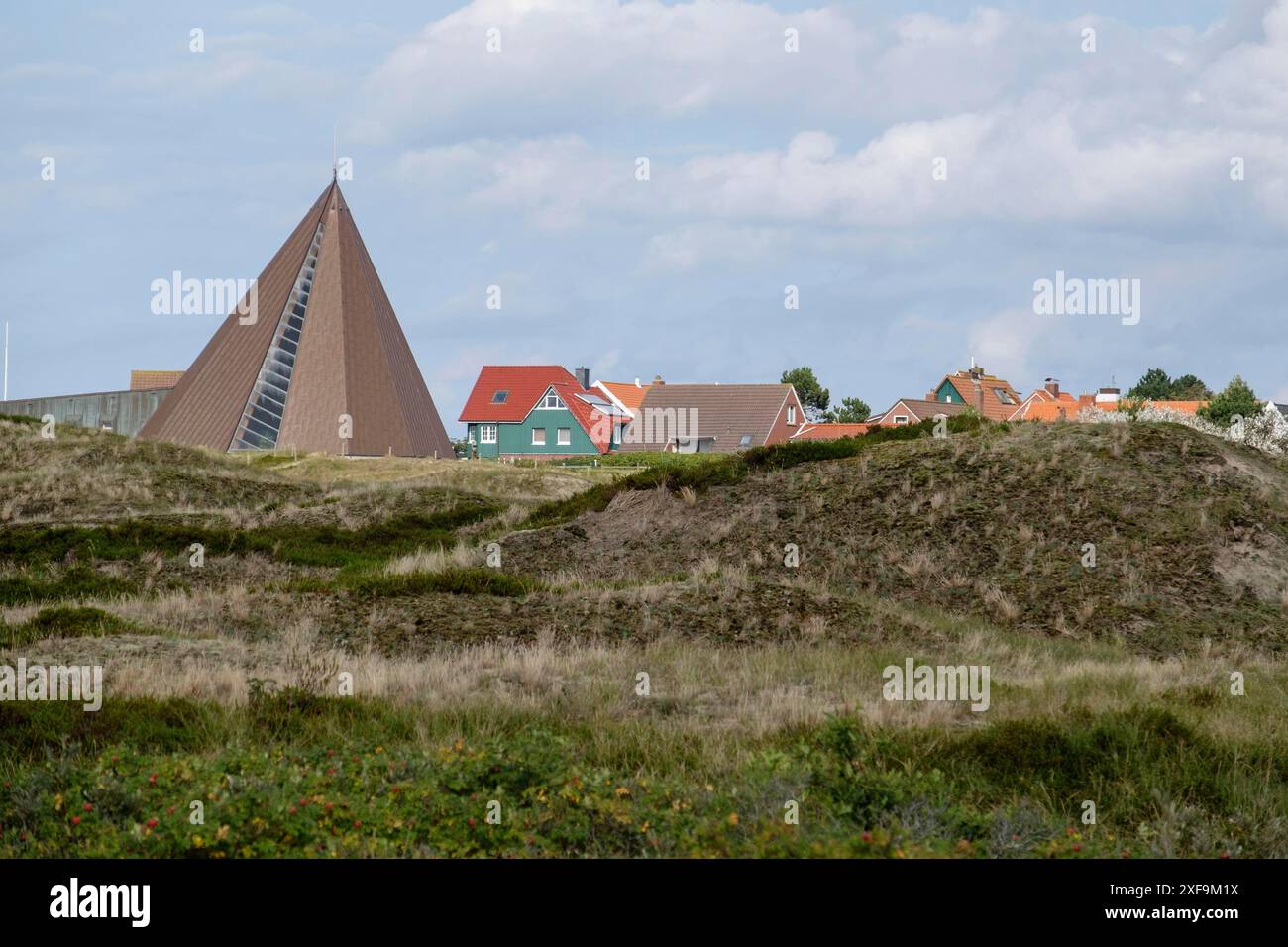 A cluster of buildings with a distinctive pyramid-like structure in a ...