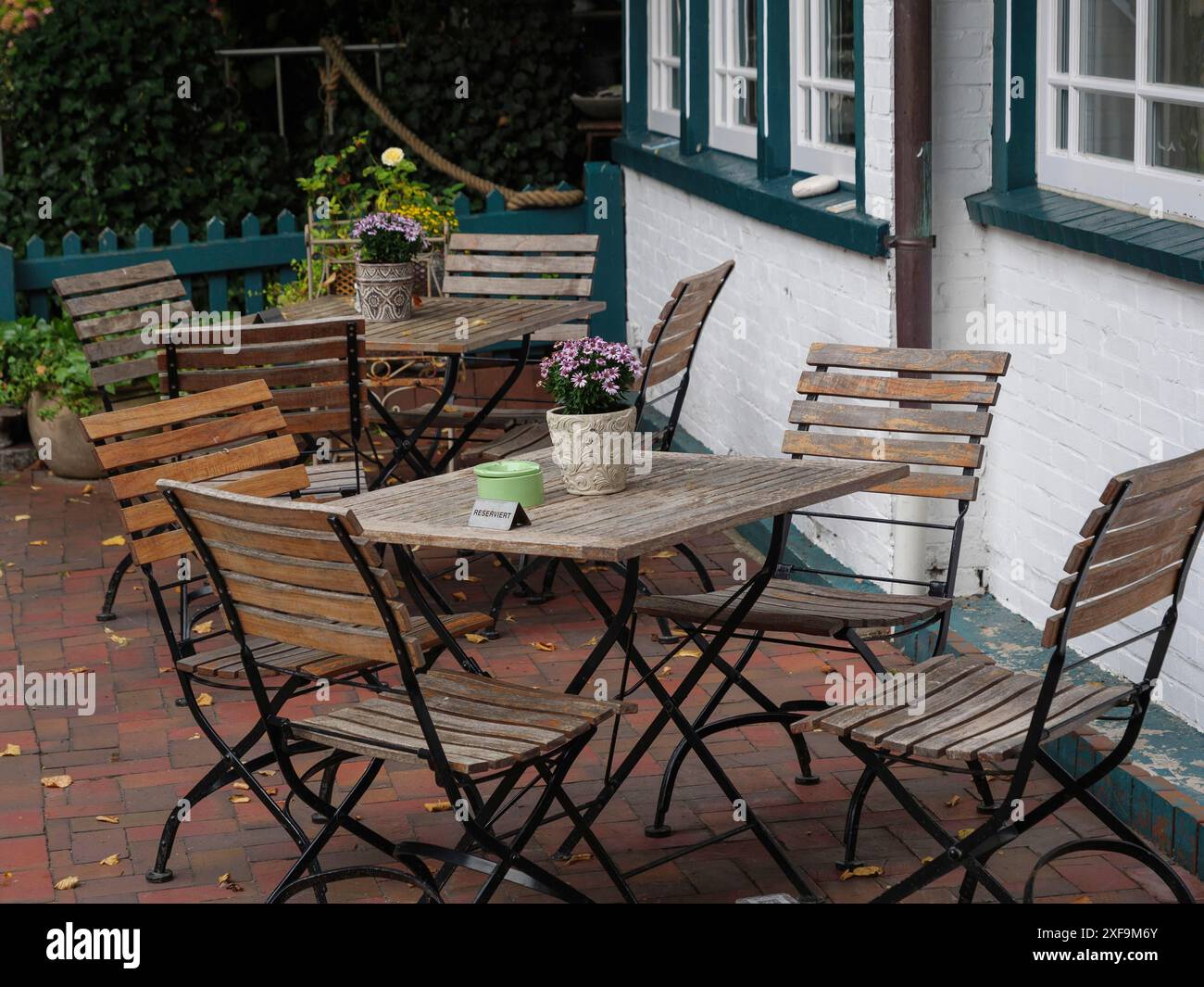 Rustic terrace with wooden furniture and flower decoration in autumn ...
