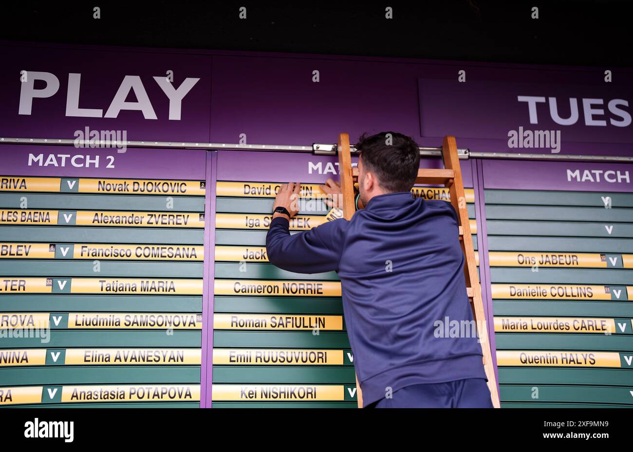 A member of the ground staff removes the name of Andy Murray and ...