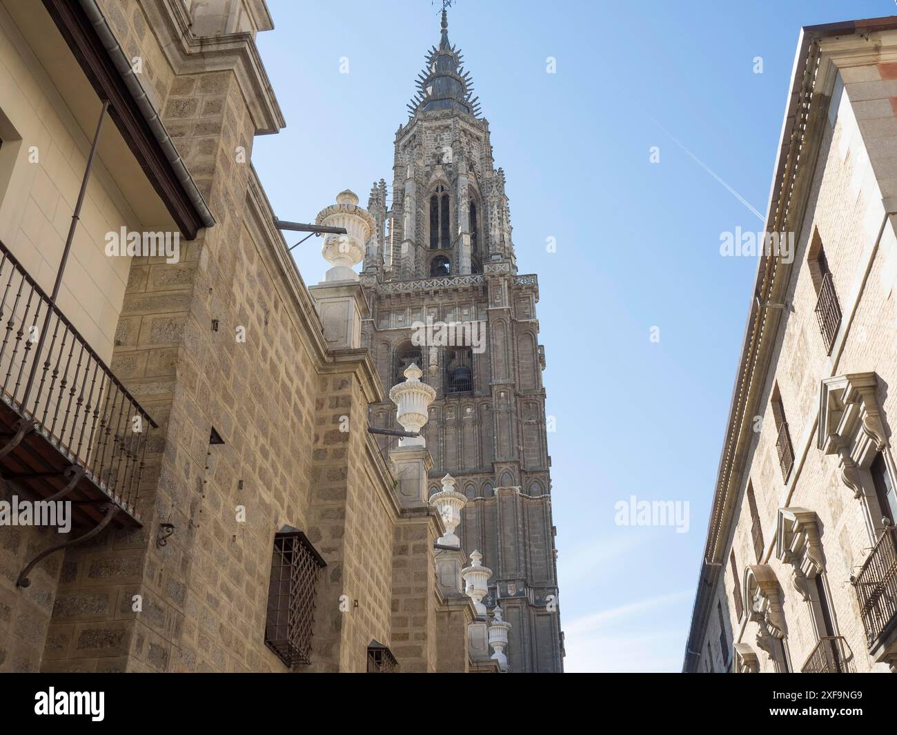 High church tower of a stone building under a blue sky, striking ...