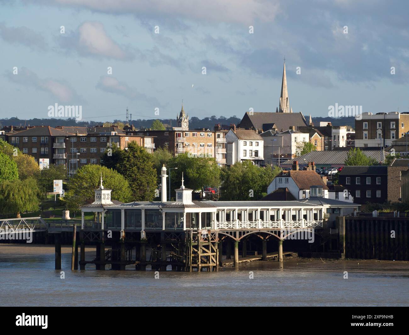 Town scene with various buildings, footbridges and church tower on the ...