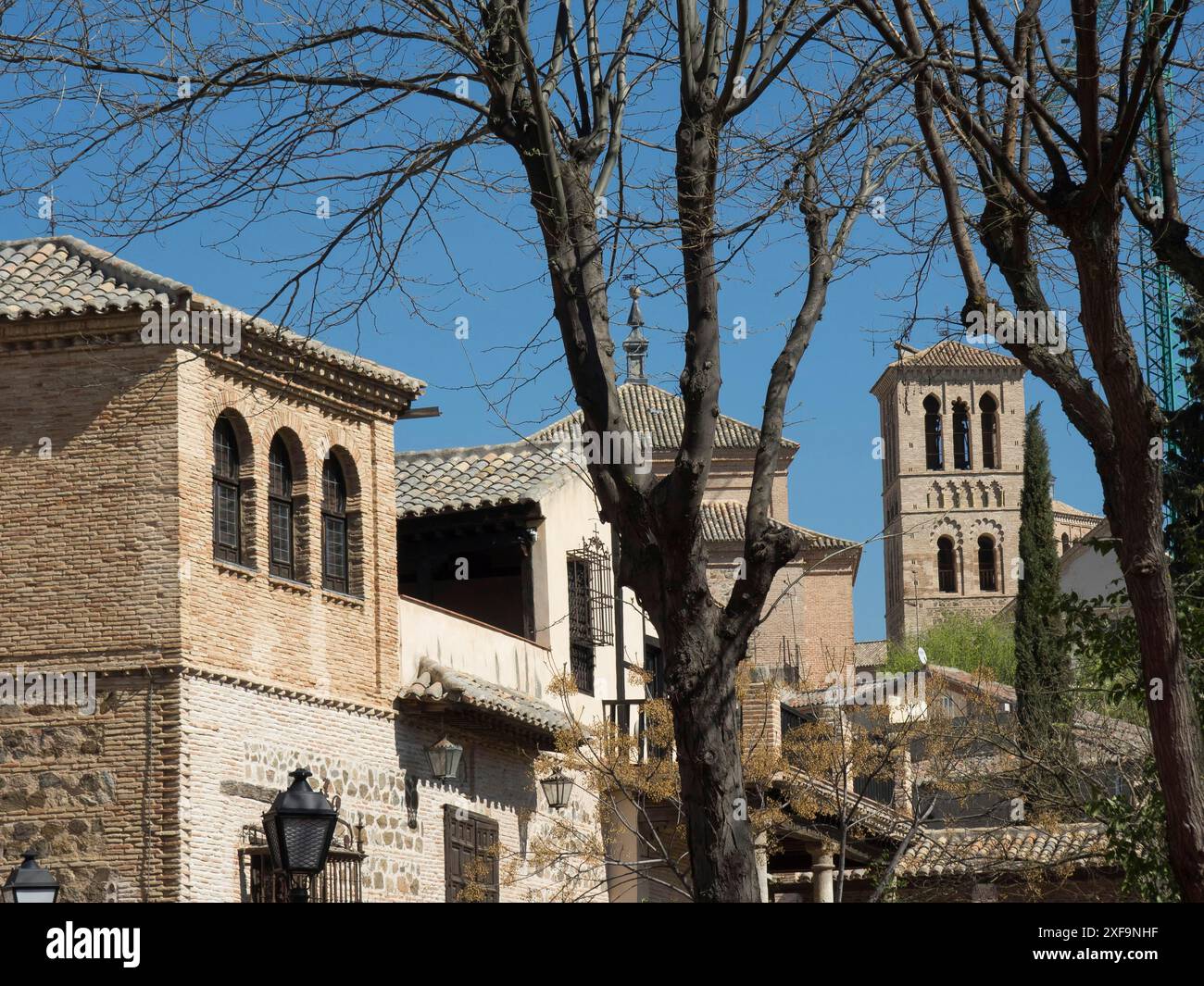 Historic buildings with towers and trees in an old town scene under a ...