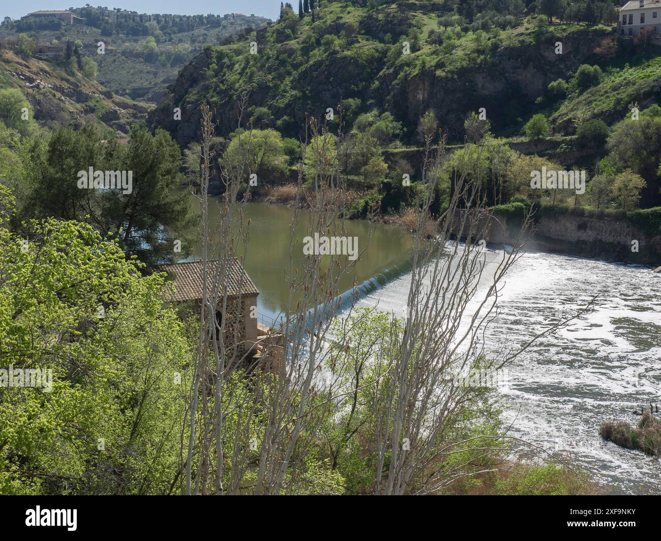 River, surrounded by green hills and trees, rich in water, peaceful ...