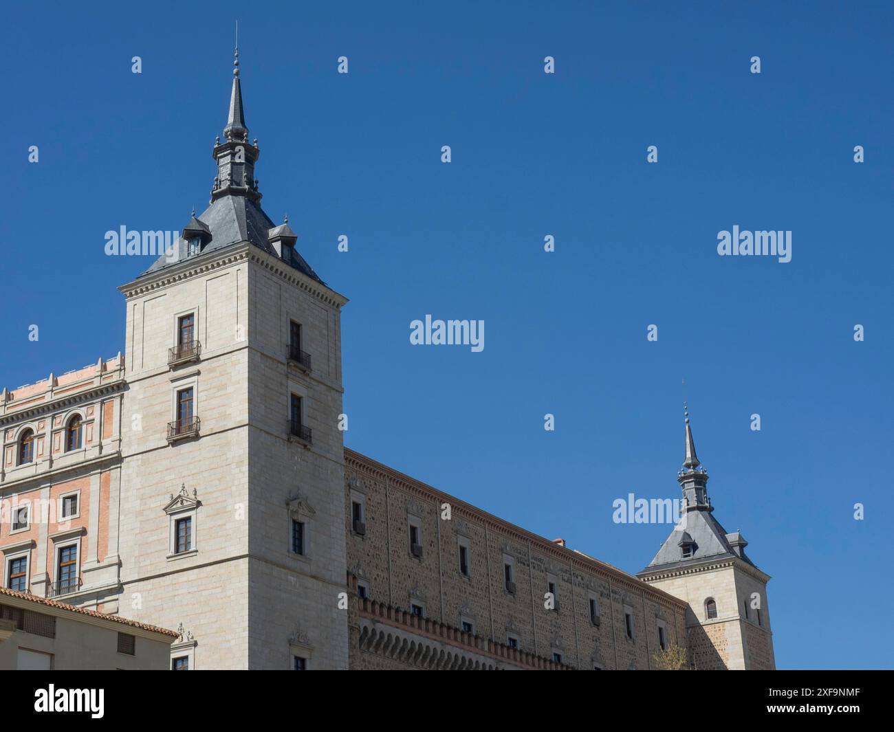 Historic building with two towers and stone walls under a blue sky ...