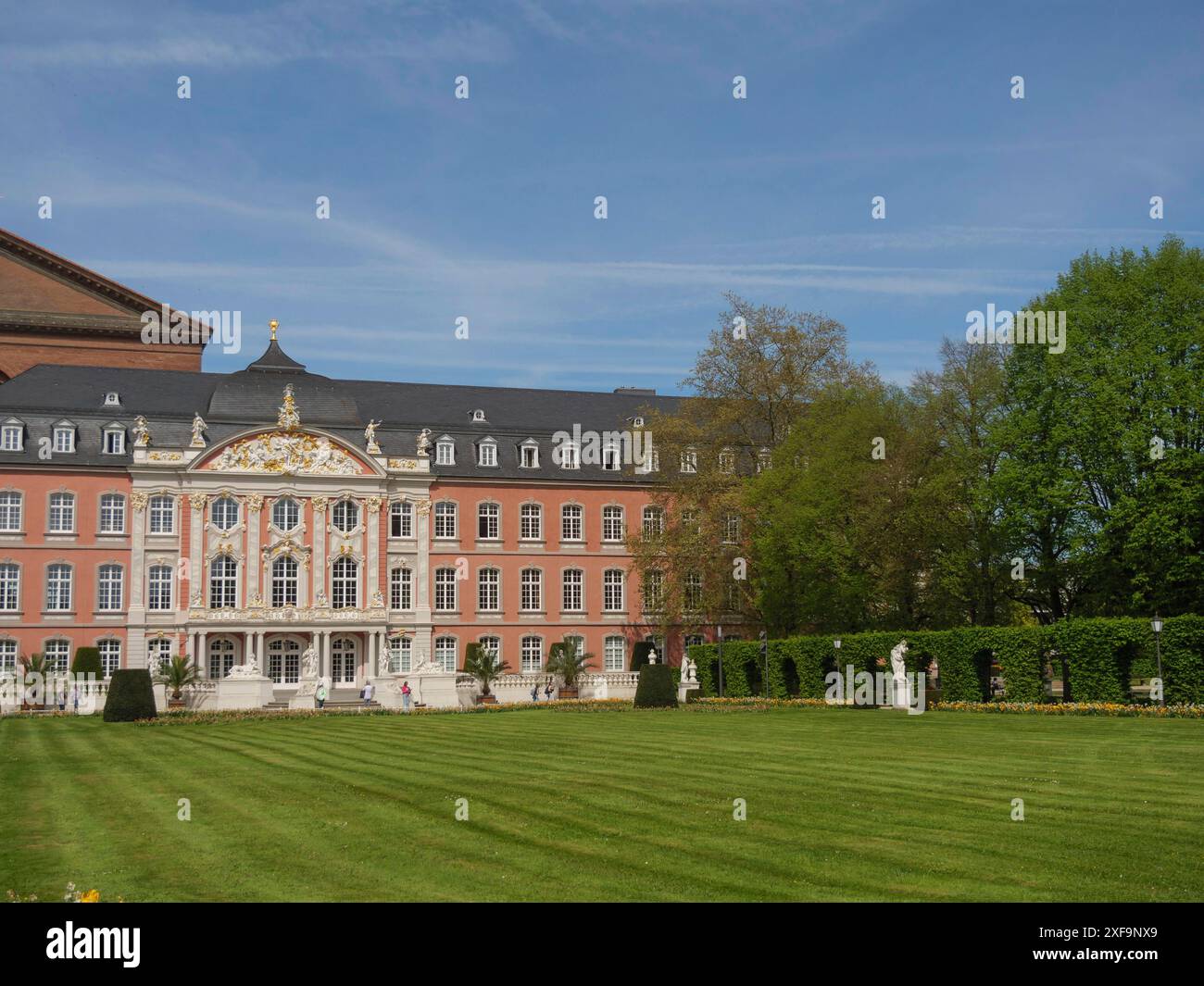 An imposing historic building with majestic gardens and green lawns ...