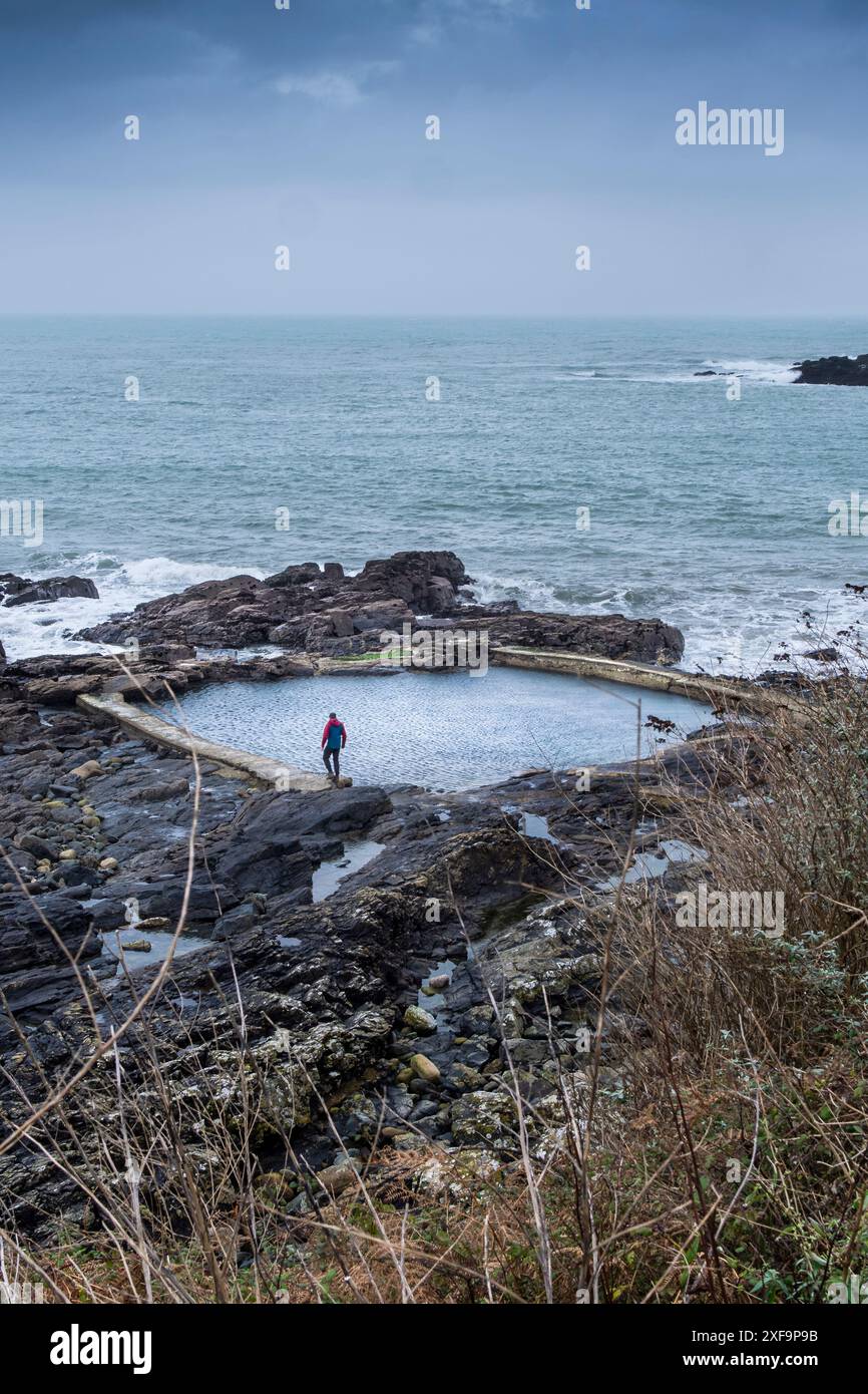The large shallow historic tidal pool on the rocky shore in Mousehole ...