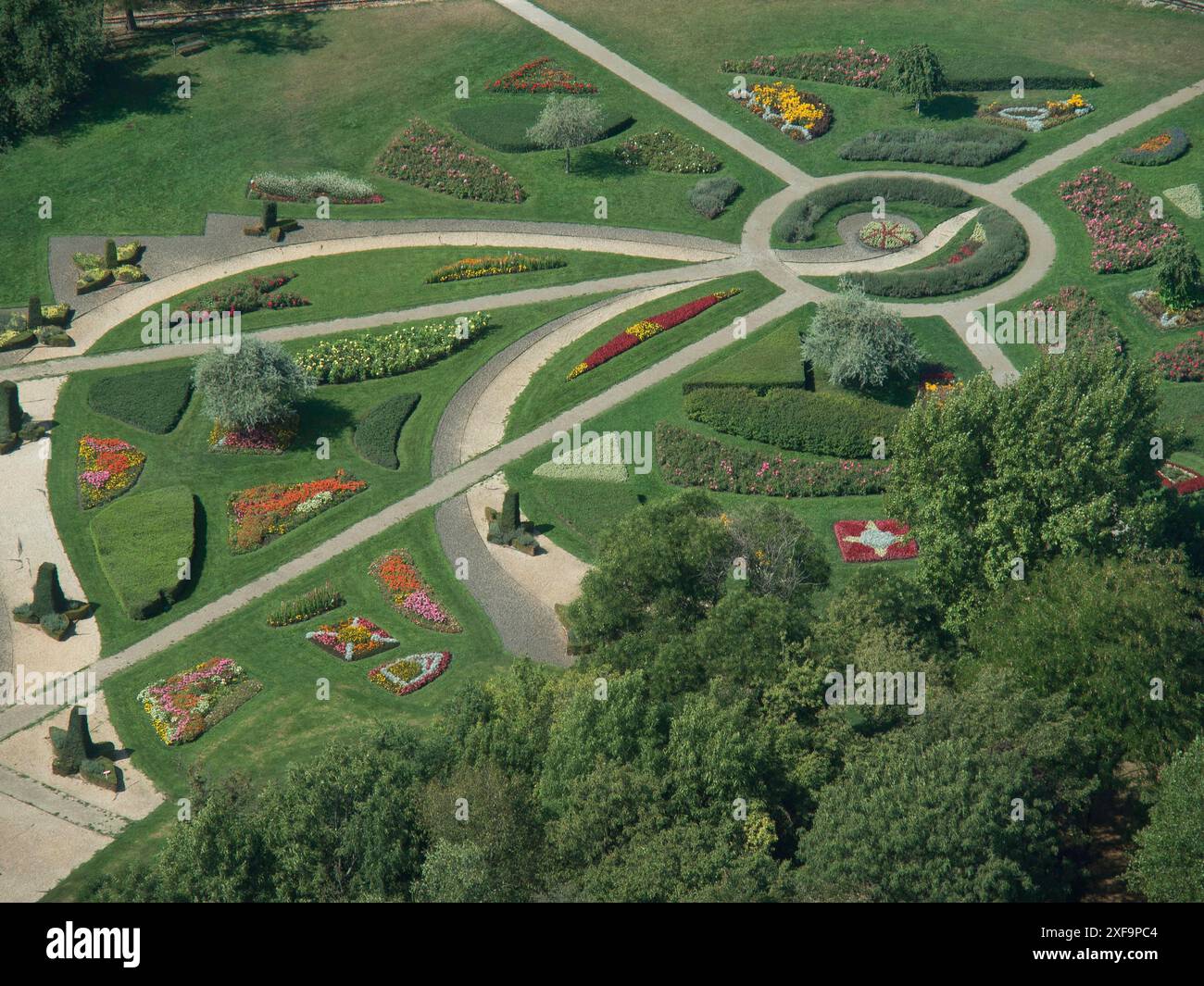 Well-tended garden with flower beds and numerous paths, surrounded by ...