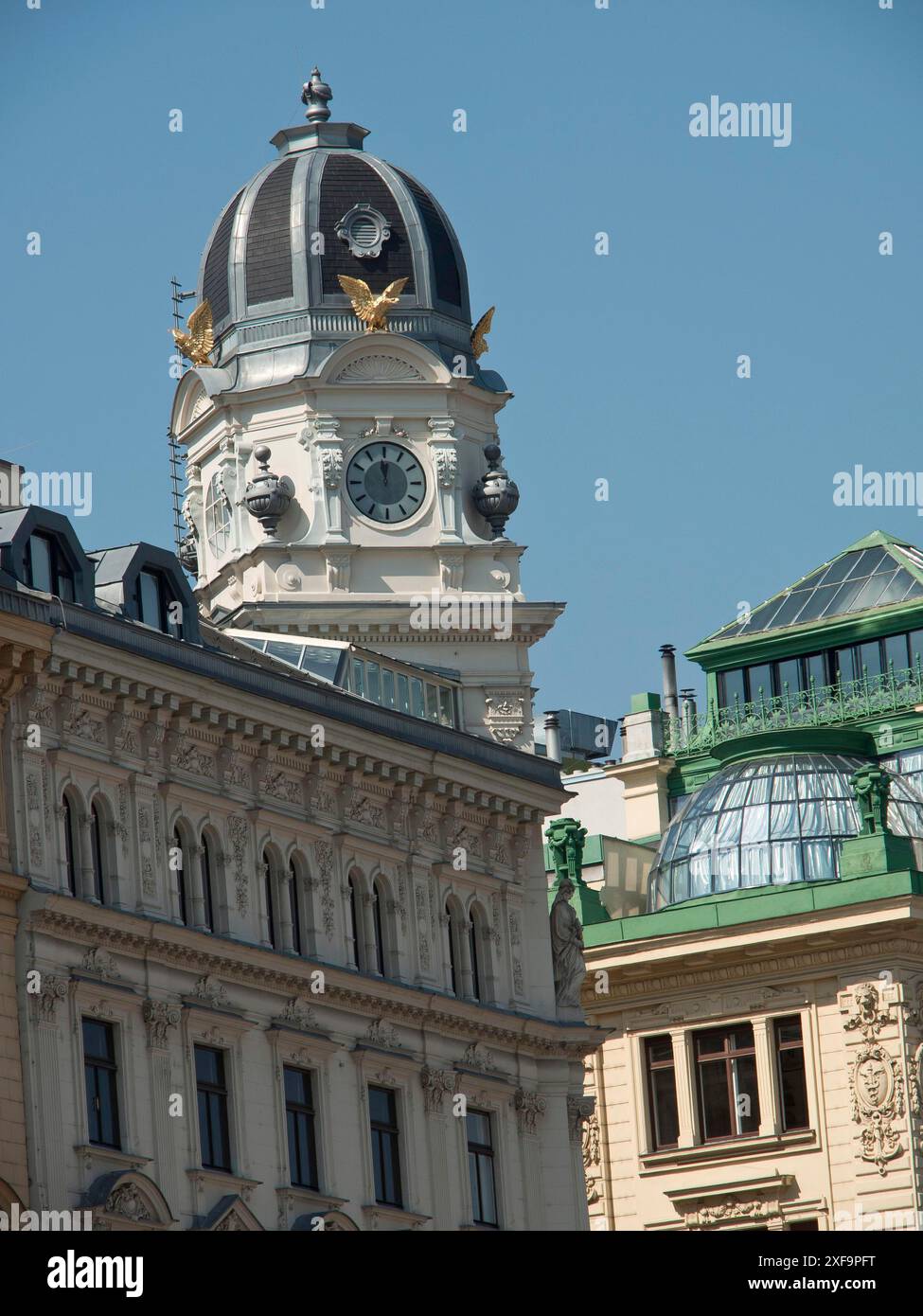 Historic clock tower with dome surrounded by classical buildings under ...