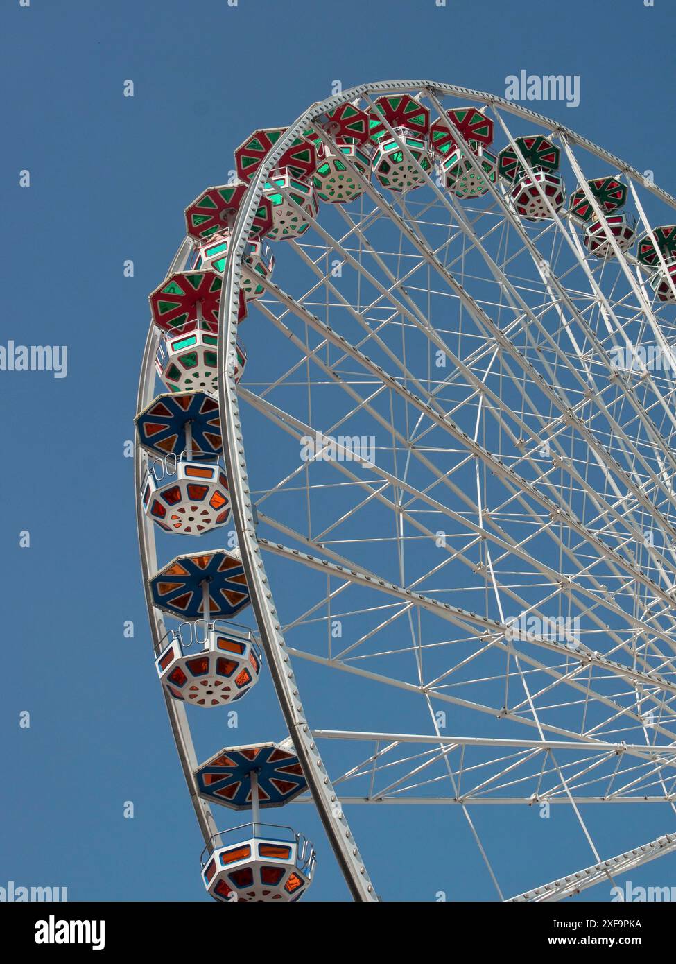 Ferris wheel with gondolas carrying Union Jack flag and other emblems ...