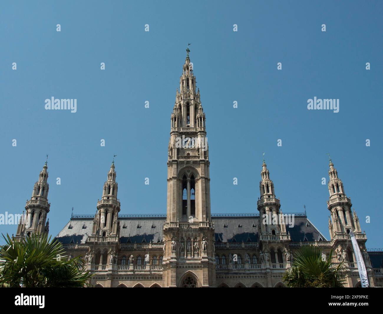 Historic city hall with several towers and a high bell tower under a ...