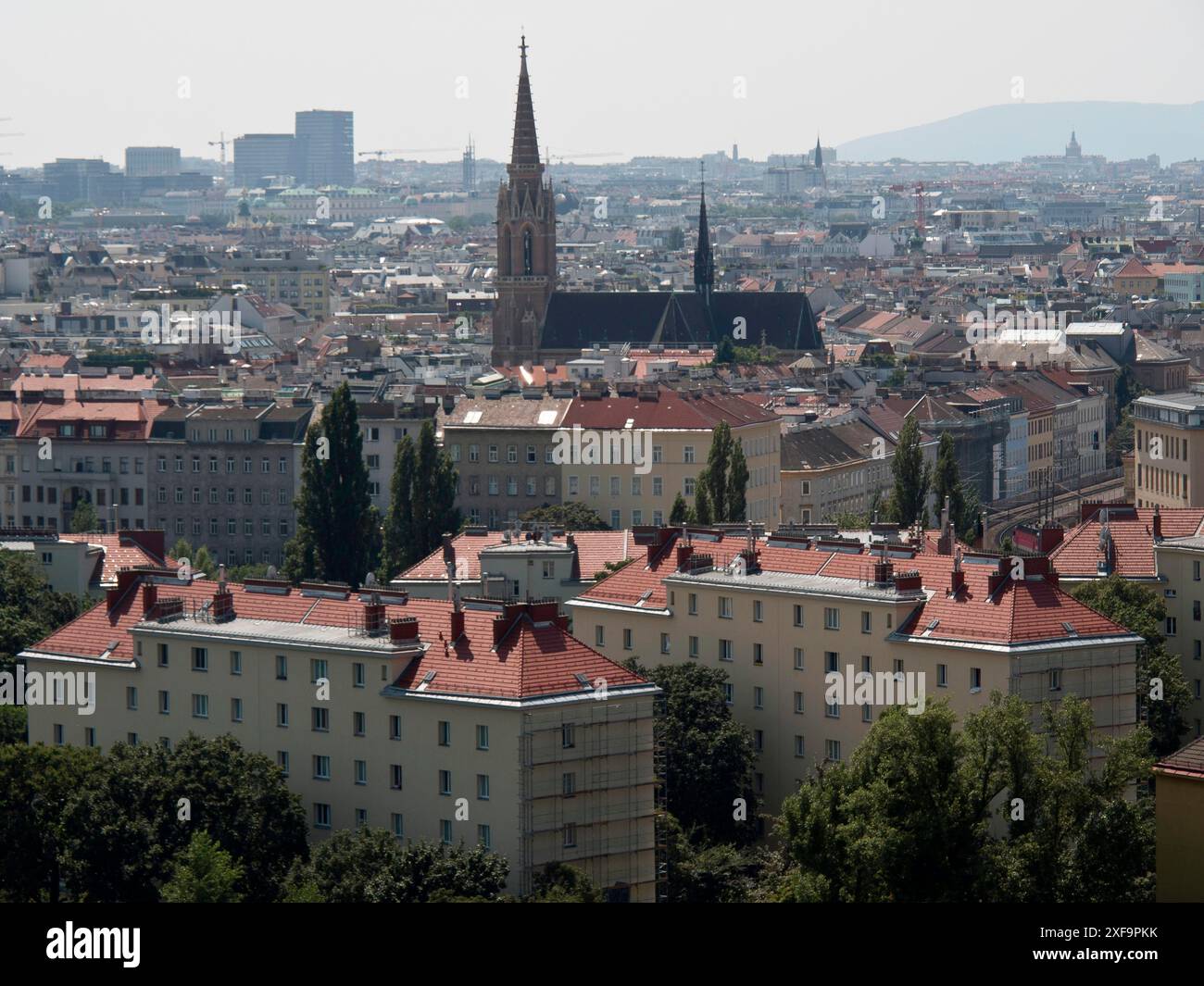 Urban panorama with many buildings, church towers and red roofs, Vienna ...