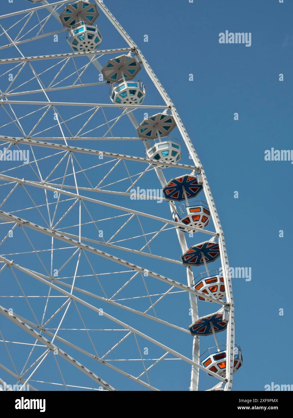 Close-up of a Ferris wheel with Union Jack and other coats of arms on ...