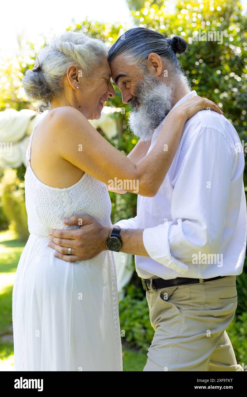 Senior bride and groom embracing and smiling outdoors, at wedding Stock ...