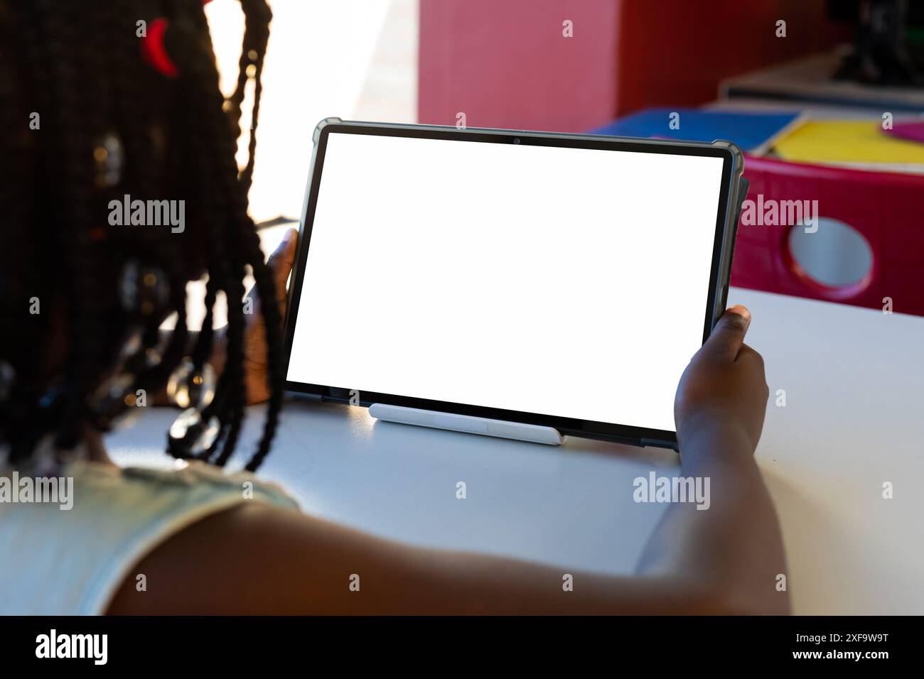 Using tablet for online learning, child studying in school classroom ...