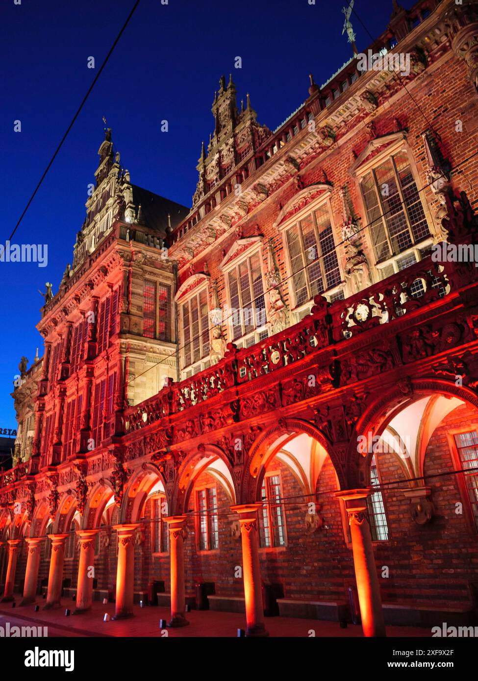 A historic building illuminated in red at night with magnificent ...