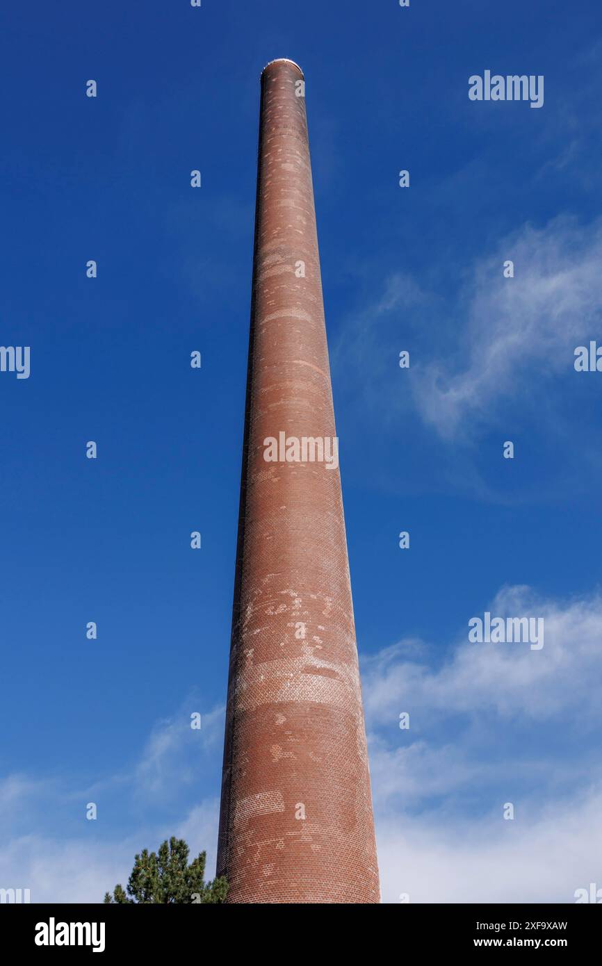 A very tall brick chimney rises into the sky, essen. ruhr area, germany ...