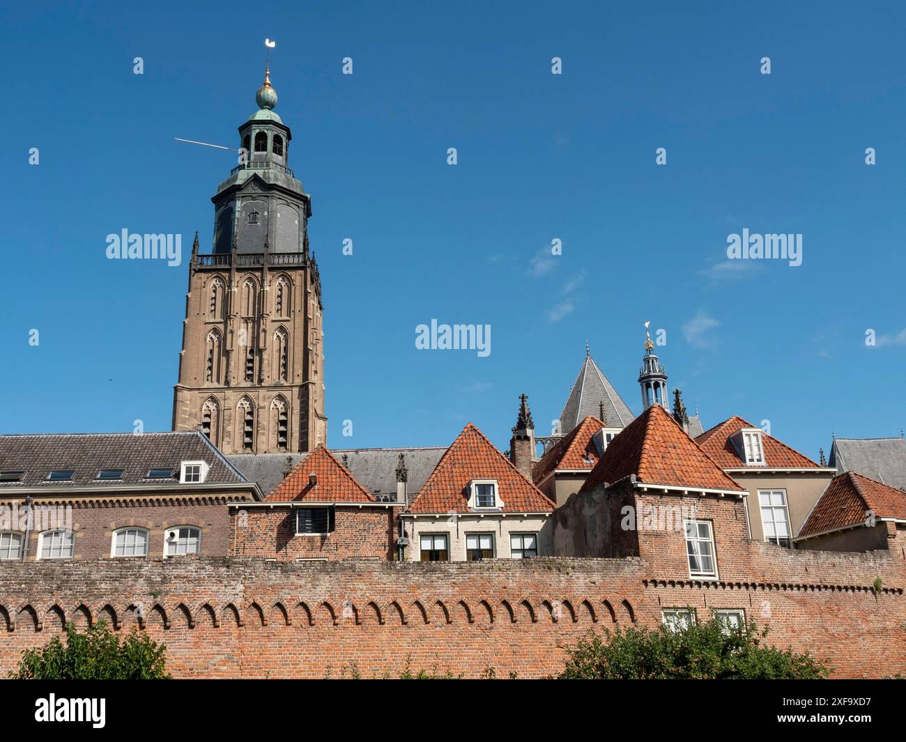 Architecturally impressive church with high spire and brick buildings ...