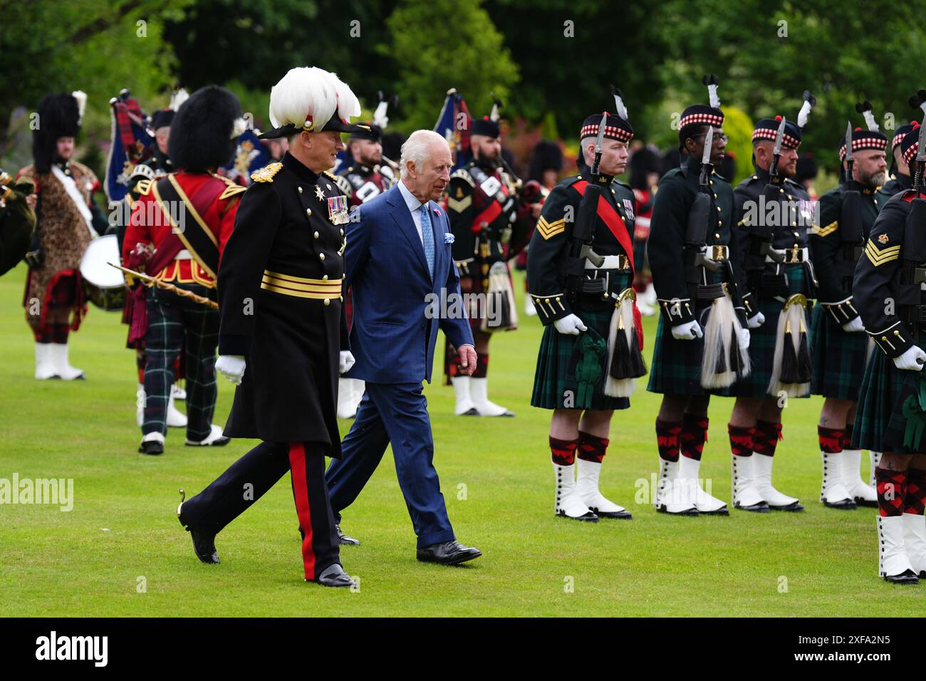 King Charles III walks with journalist and television correspondent ...