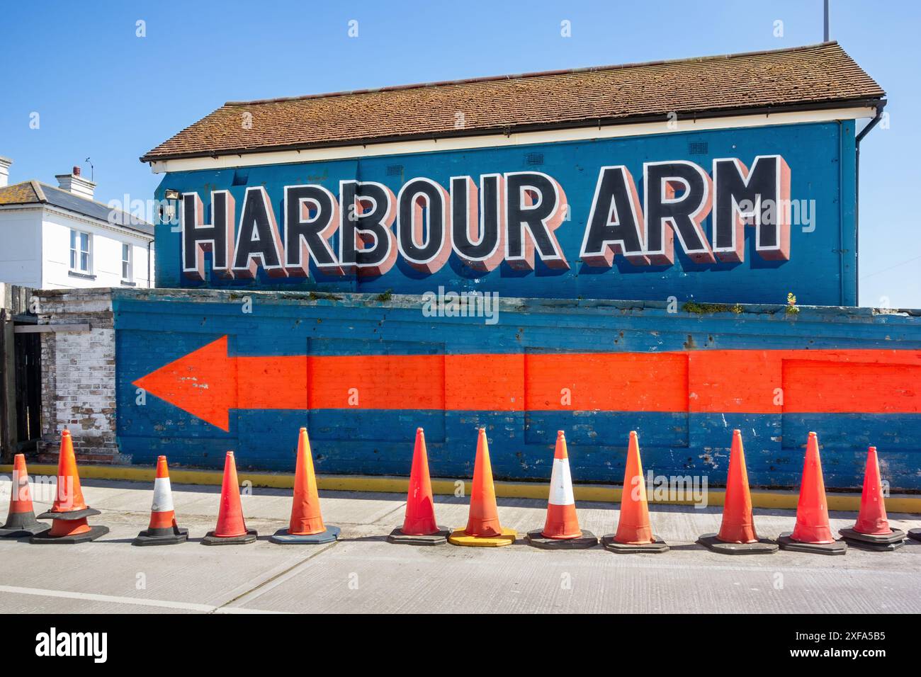 The Harbour Arm sign features a large orange arrow set against a vivid ...