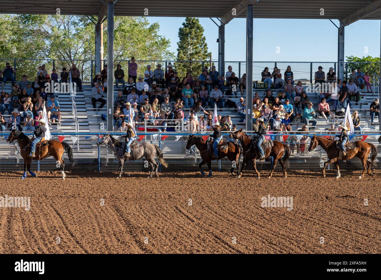 Young cowgirls & cowboys ride past the grandstand during the Grand ...