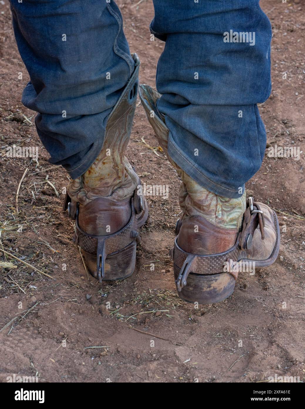 Boots and dull-roweled spurs of a rodeo cowboy before his bareback ...