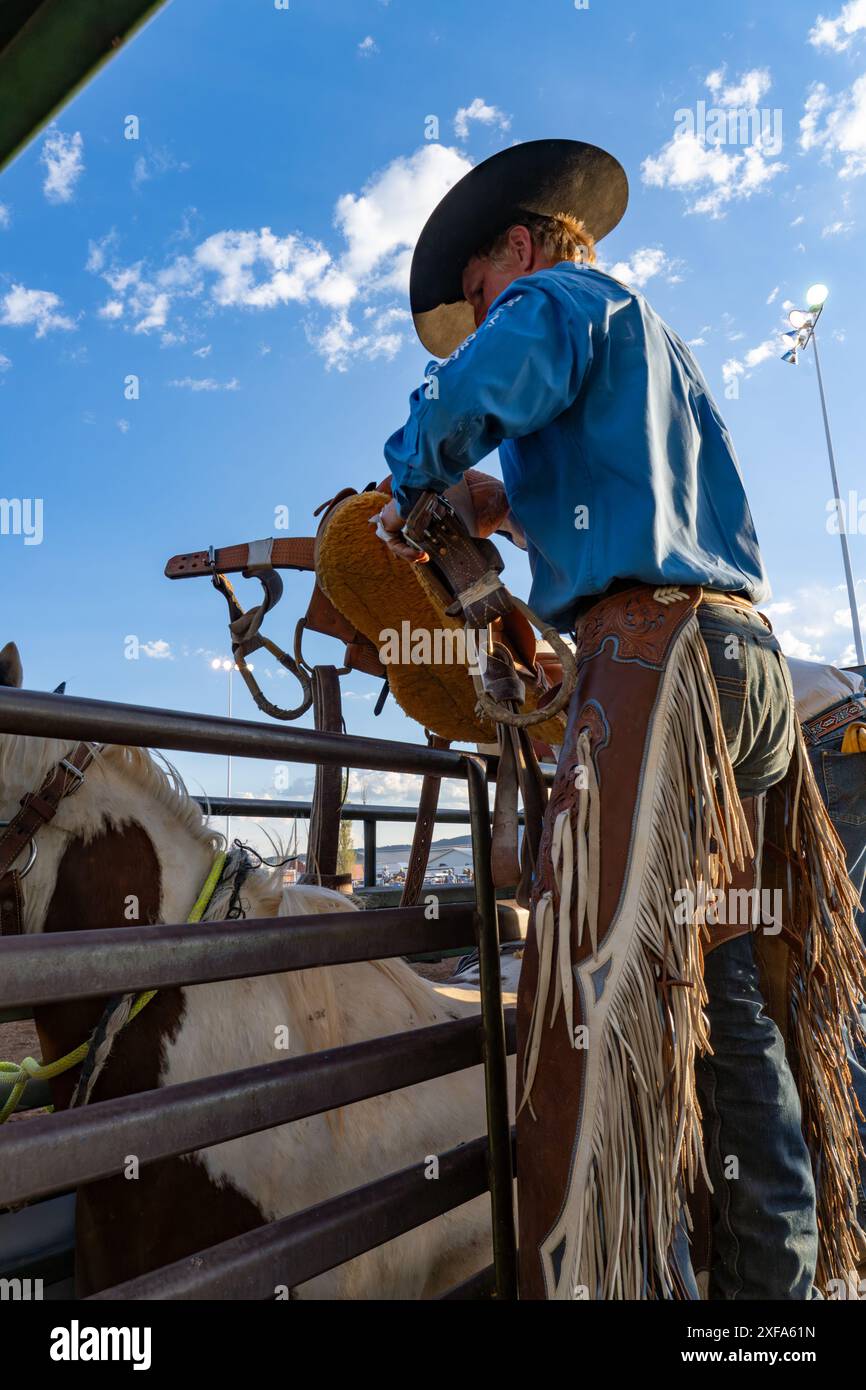 Saddle bronc cowboy Josh Davison saddles up the bucking horse in the ...