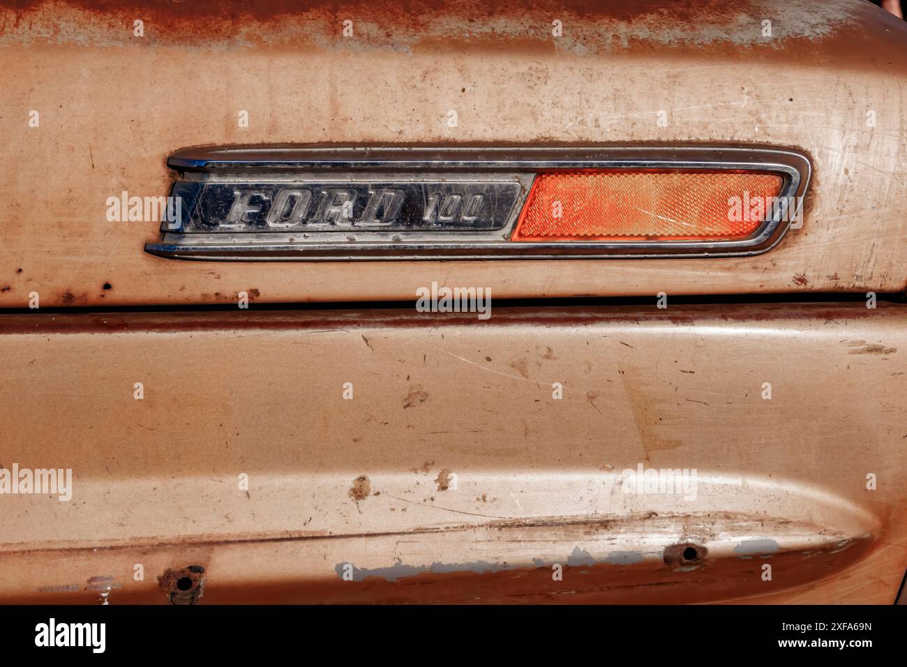 closeup detail of vintage american Ford 100 badge logo and indicator ...