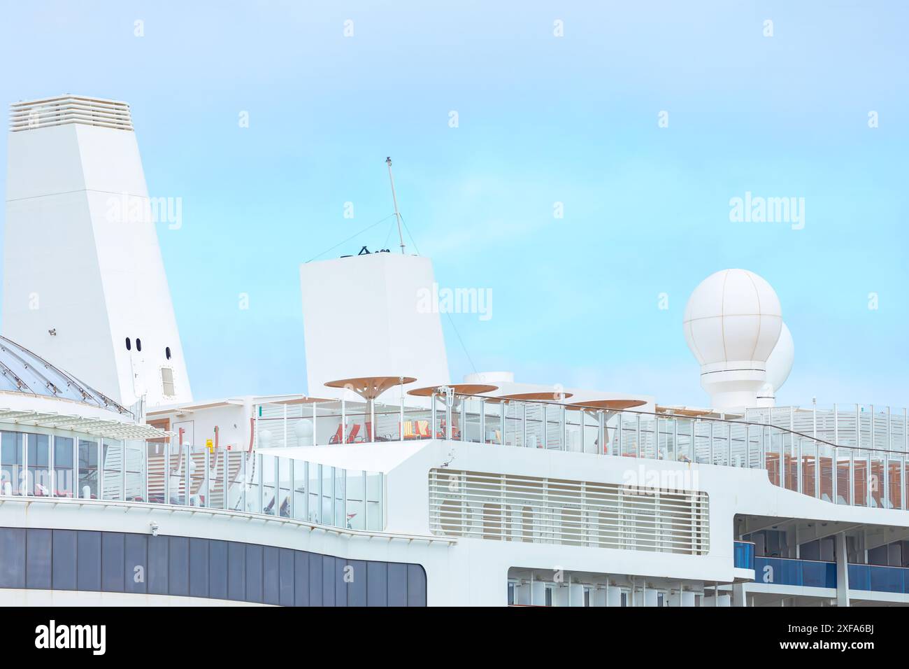 Cruise ship is seen from the top, with a large white tower in the ...