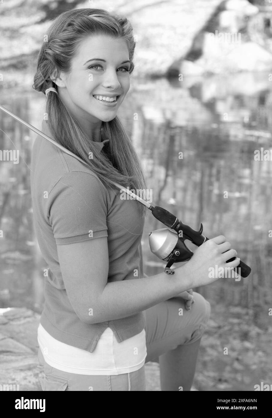 Caucasian teen girl from 15 to 17 years holding fishing rod and reel at ...