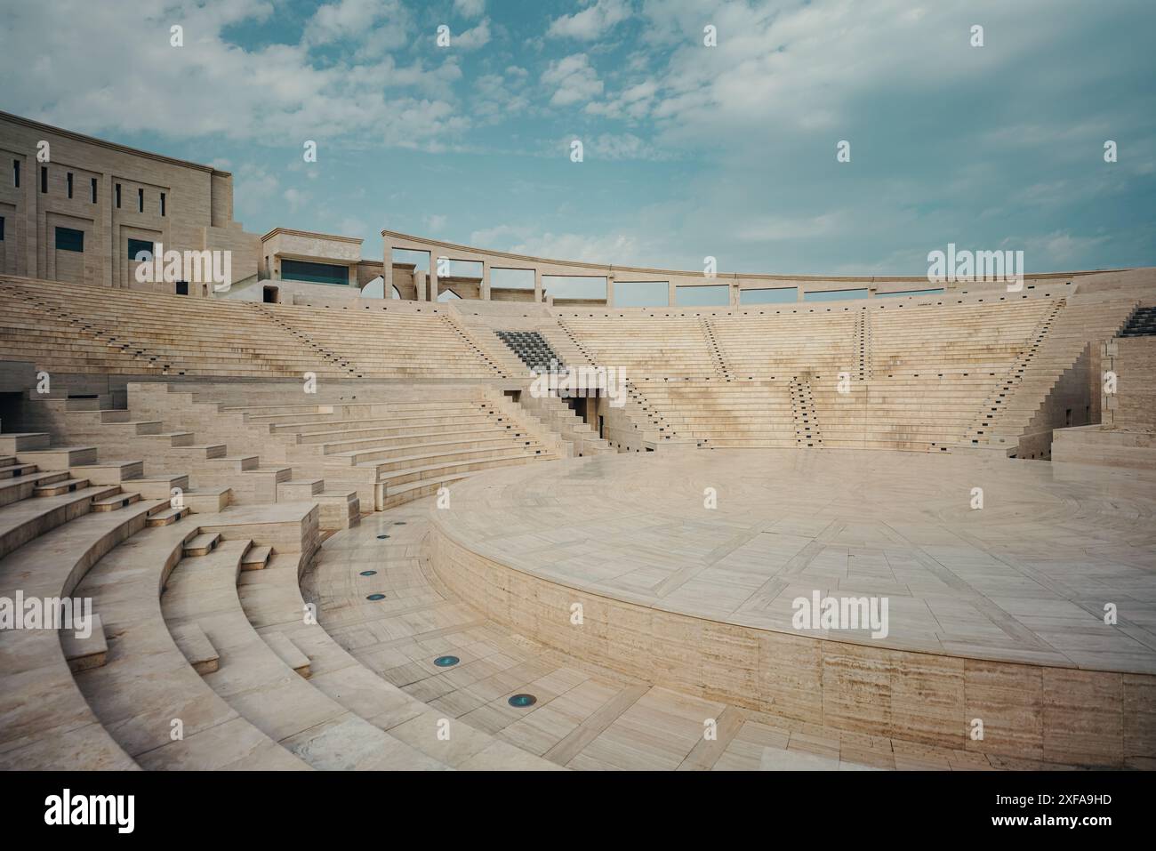 Amphitheater with stone seating and a clear sky in Katara Cultural ...