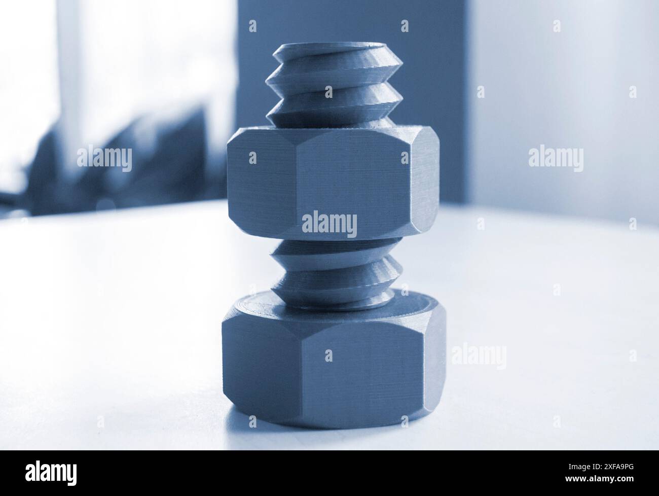 Object in form of washer and bolt printed on 3D printer. Three ...